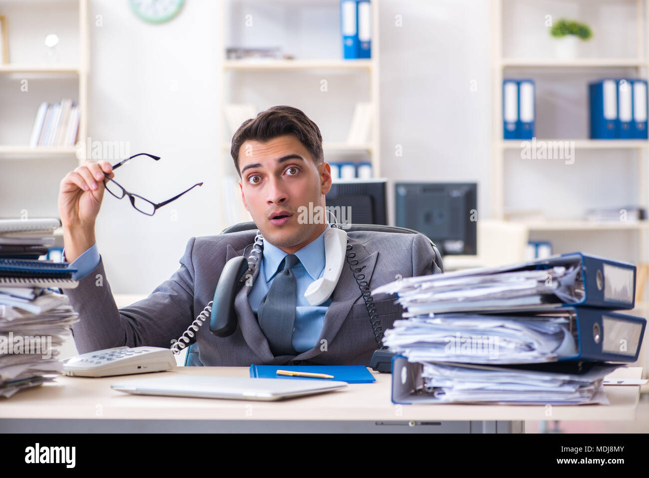 Desperate sad employee tired at his desk in call center Stock Photo - Alamy