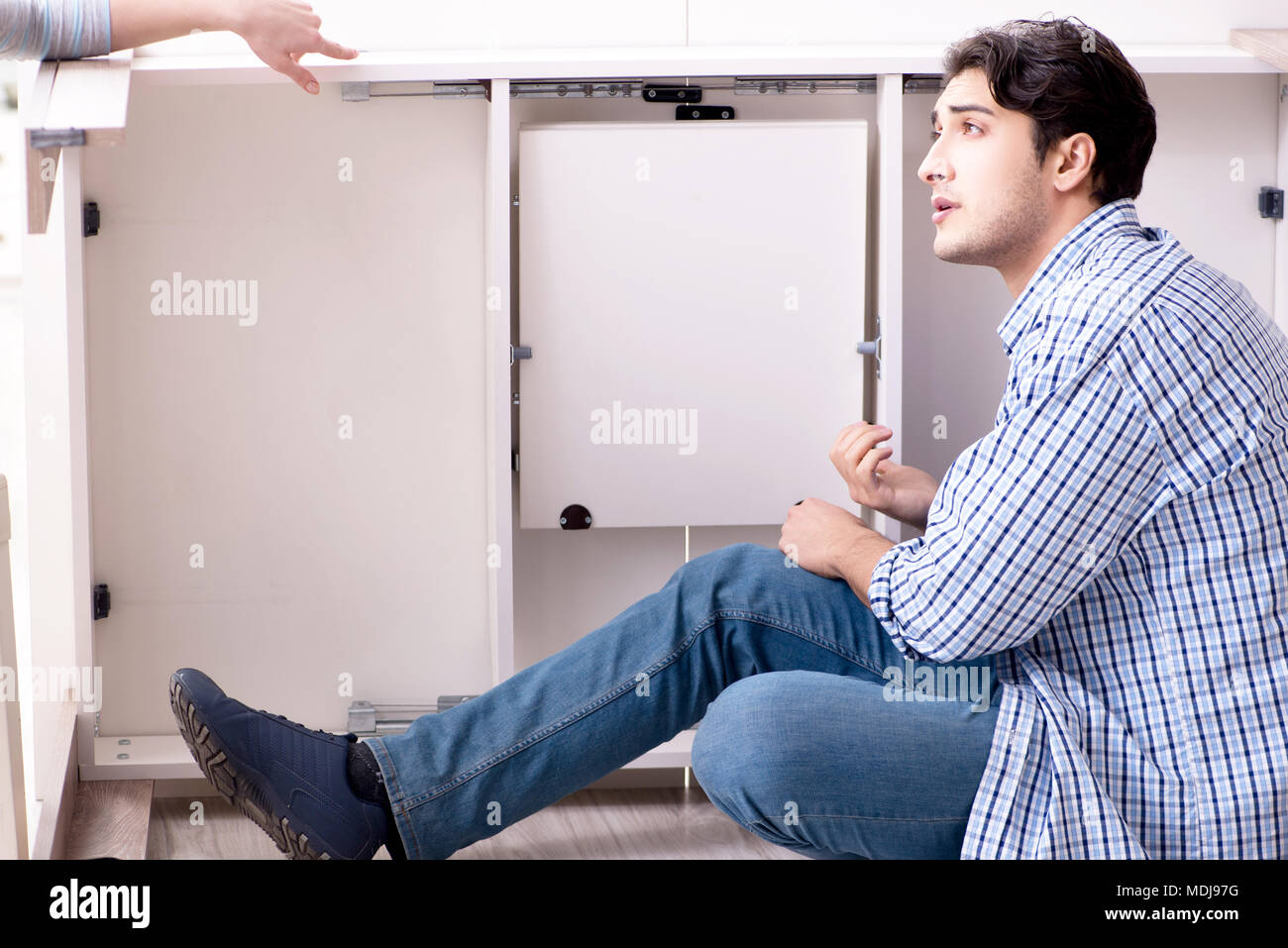 Husband repairing broken table at home Stock Photo - Alamy
