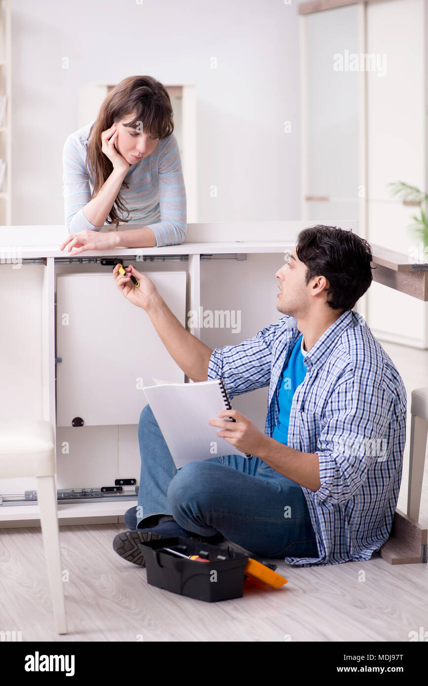 Husband repairing broken table at home Stock Photo - Alamy