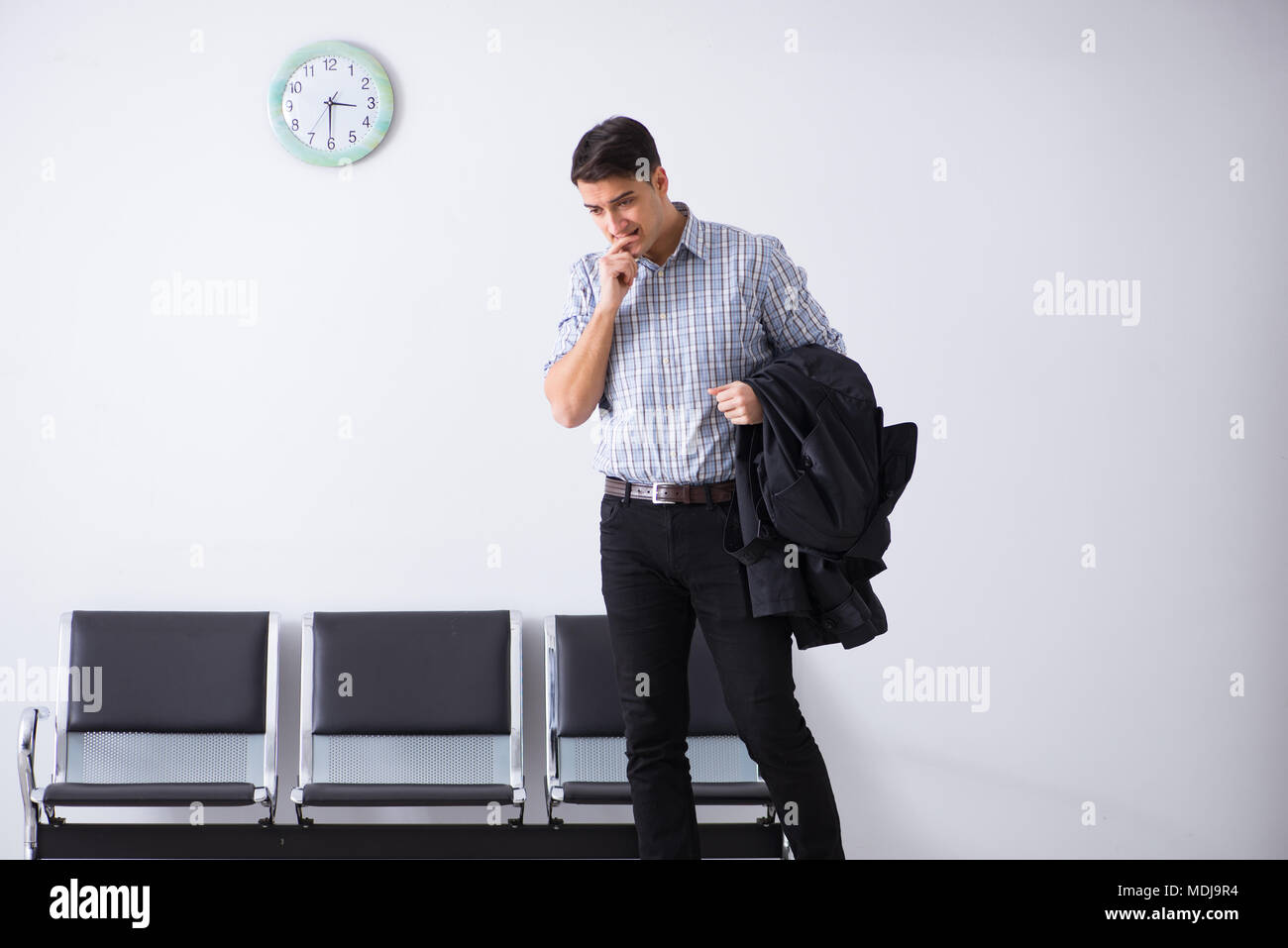Man nervously impatiently waiting in the lobby Stock Photo - Alamy
