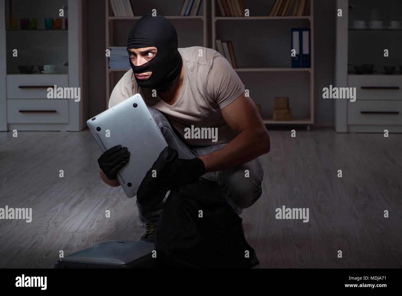 Burglar wearing balaclava mask at crime scene Stock Photo - Alamy