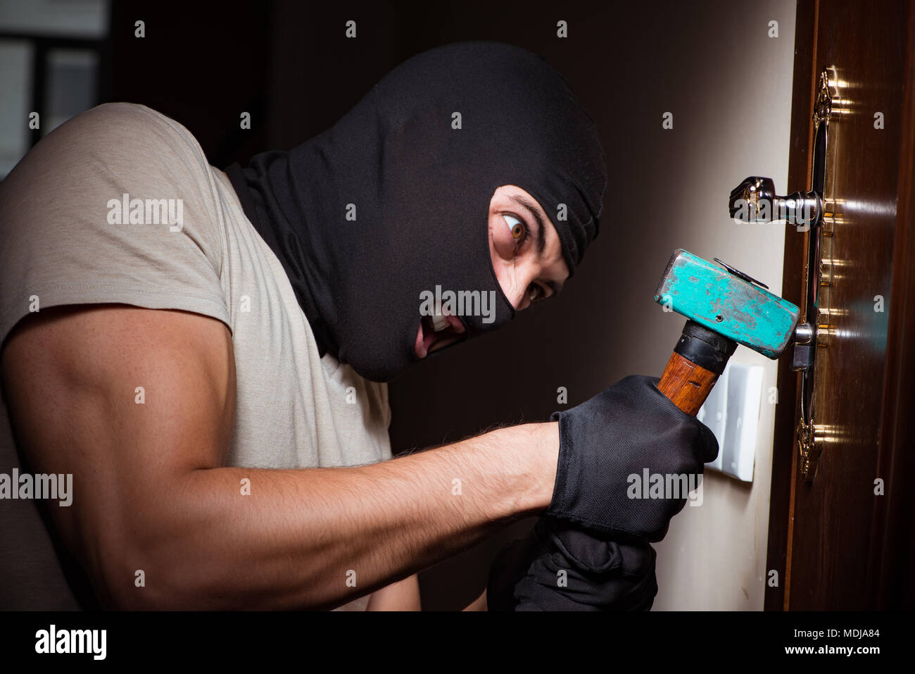 Burglar wearing balaclava mask at crime scene Stock Photo - Alamy