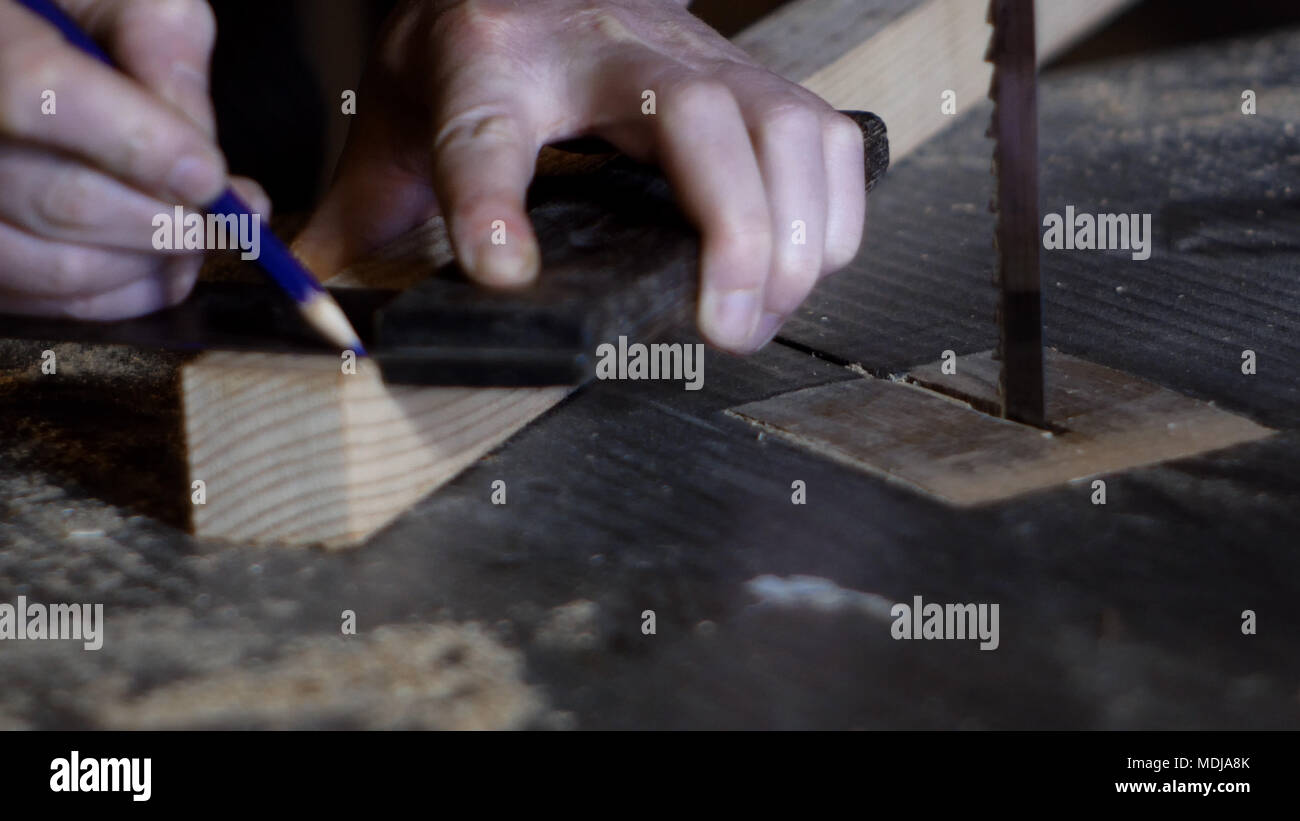 detail hands of a carpenter measuring with a carpenter's meter Stock ...