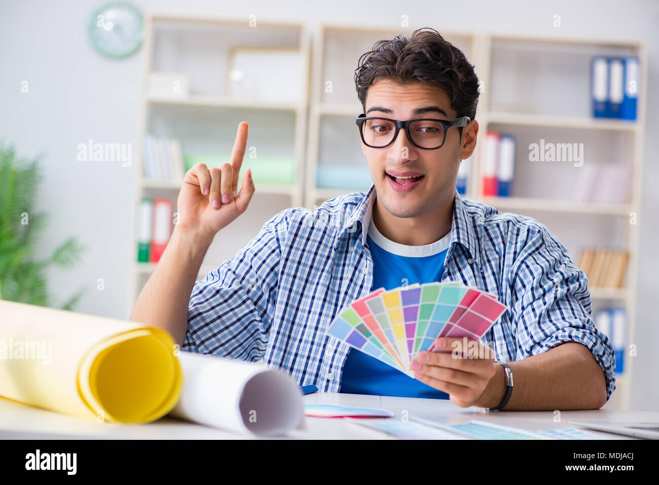 Young designer working on new project and choosing colours Stock Photo ...