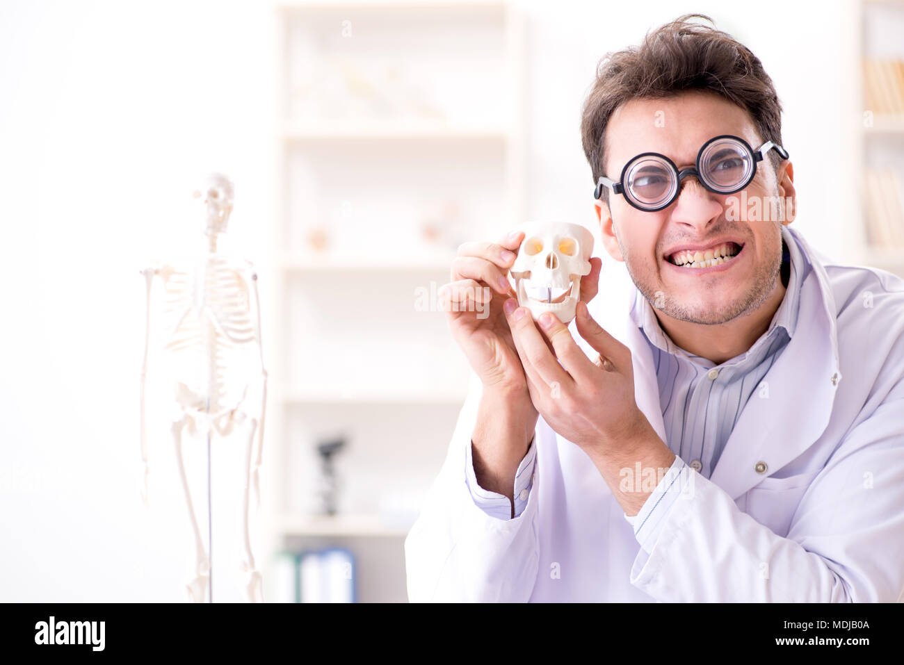 Crazy doctor studying human skeleton Stock Photo - Alamy