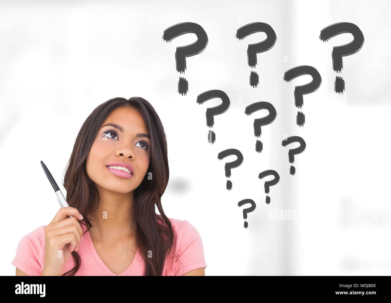 Woman thinking with question marks Stock Photo - Alamy