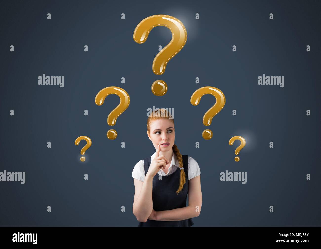 Woman thinking with gold question marks Stock Photo - Alamy
