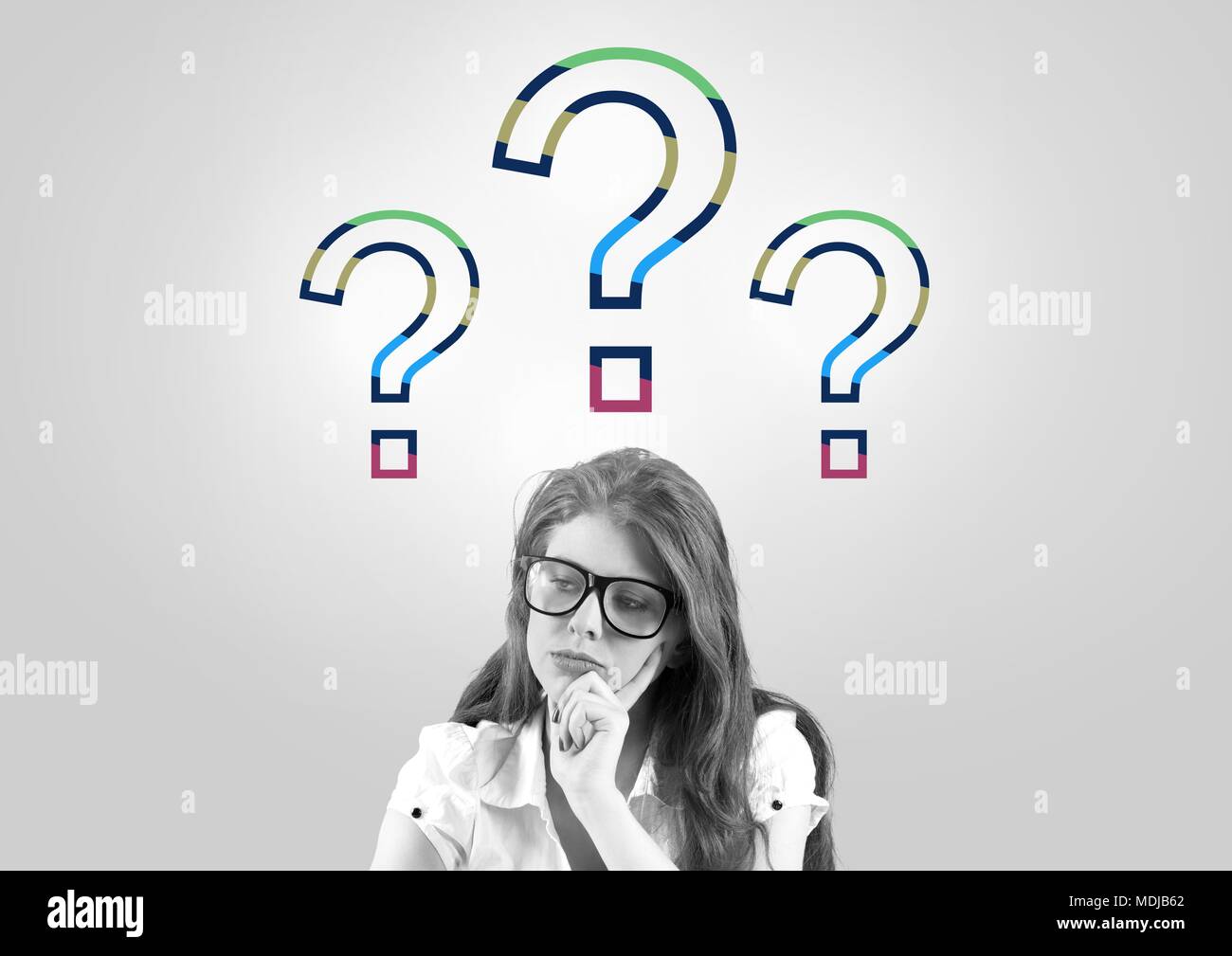 Woman thinking with question marks Stock Photo - Alamy