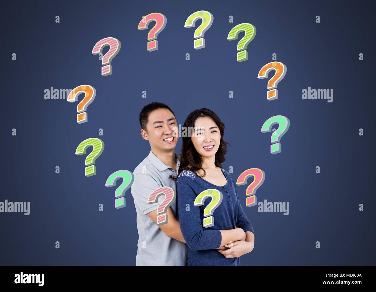 Couple with colorful funky question marks Stock Photo - Alamy