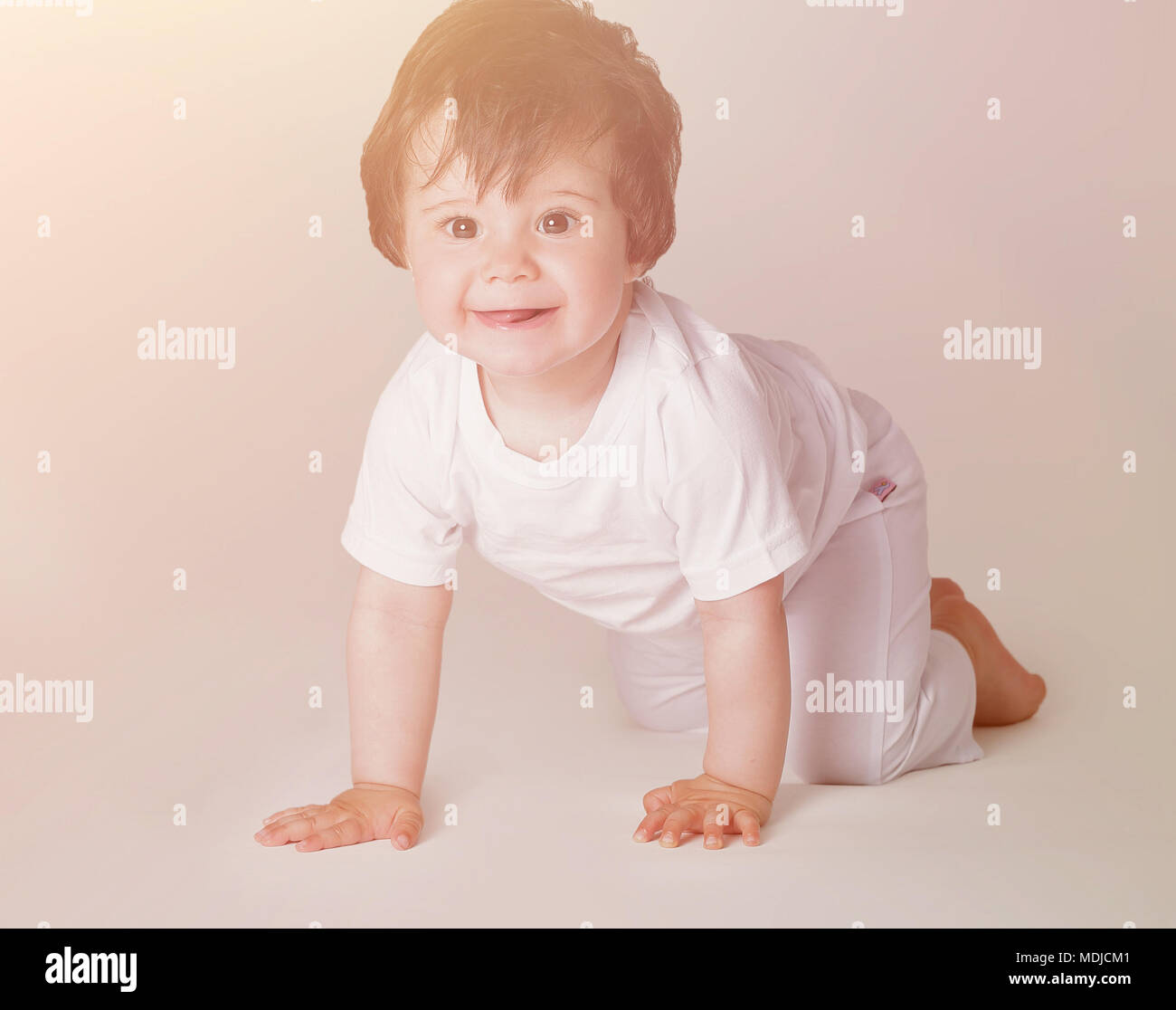 Happy crawling baby. Side view Stock Photo - Alamy