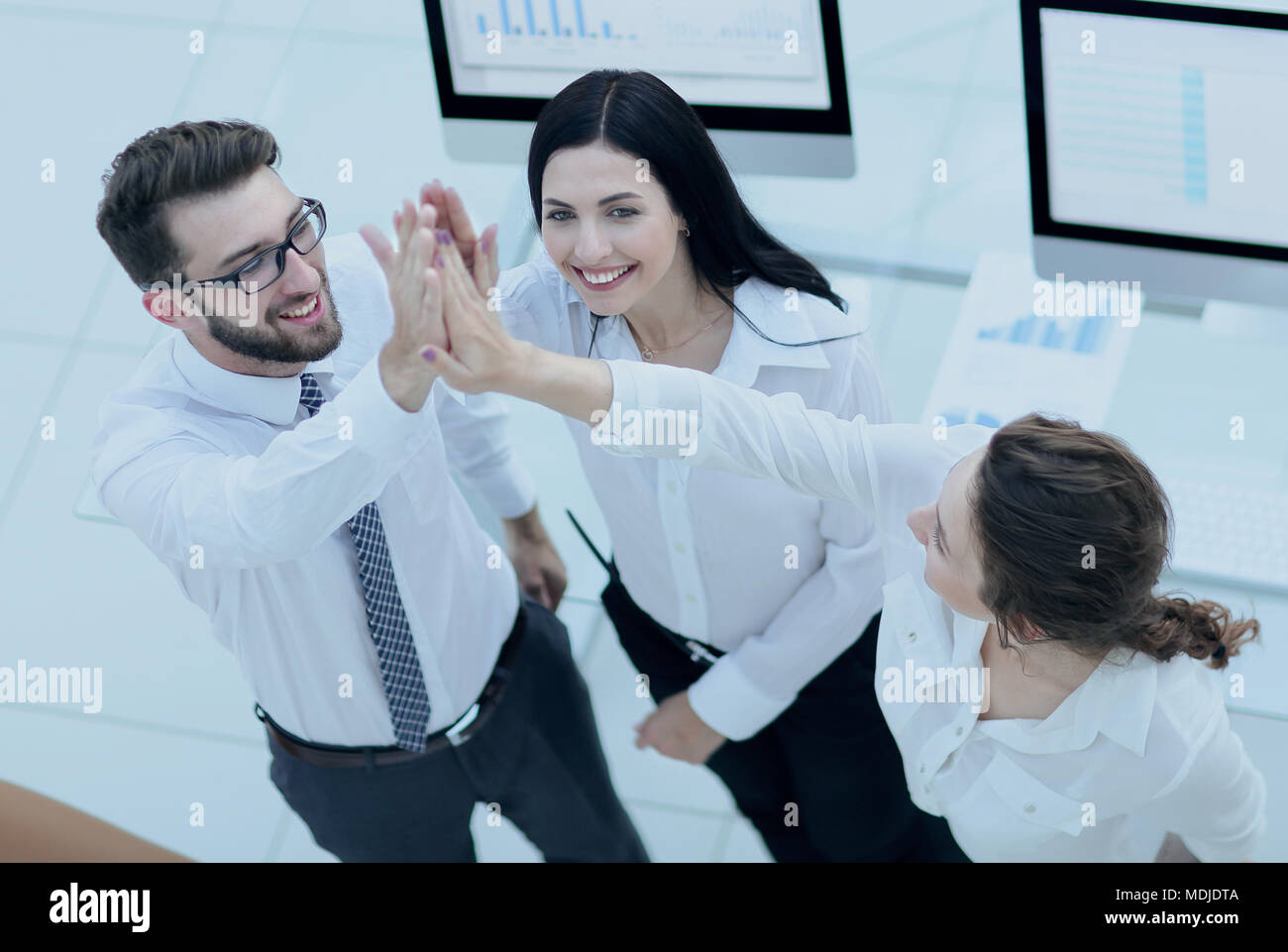 successful business team giving each other a high five Stock Photo - Alamy