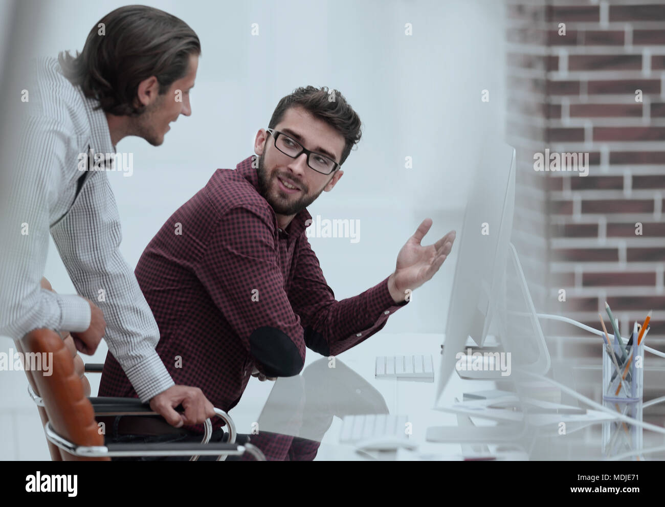 two office employee talking in the office Stock Photo - Alamy