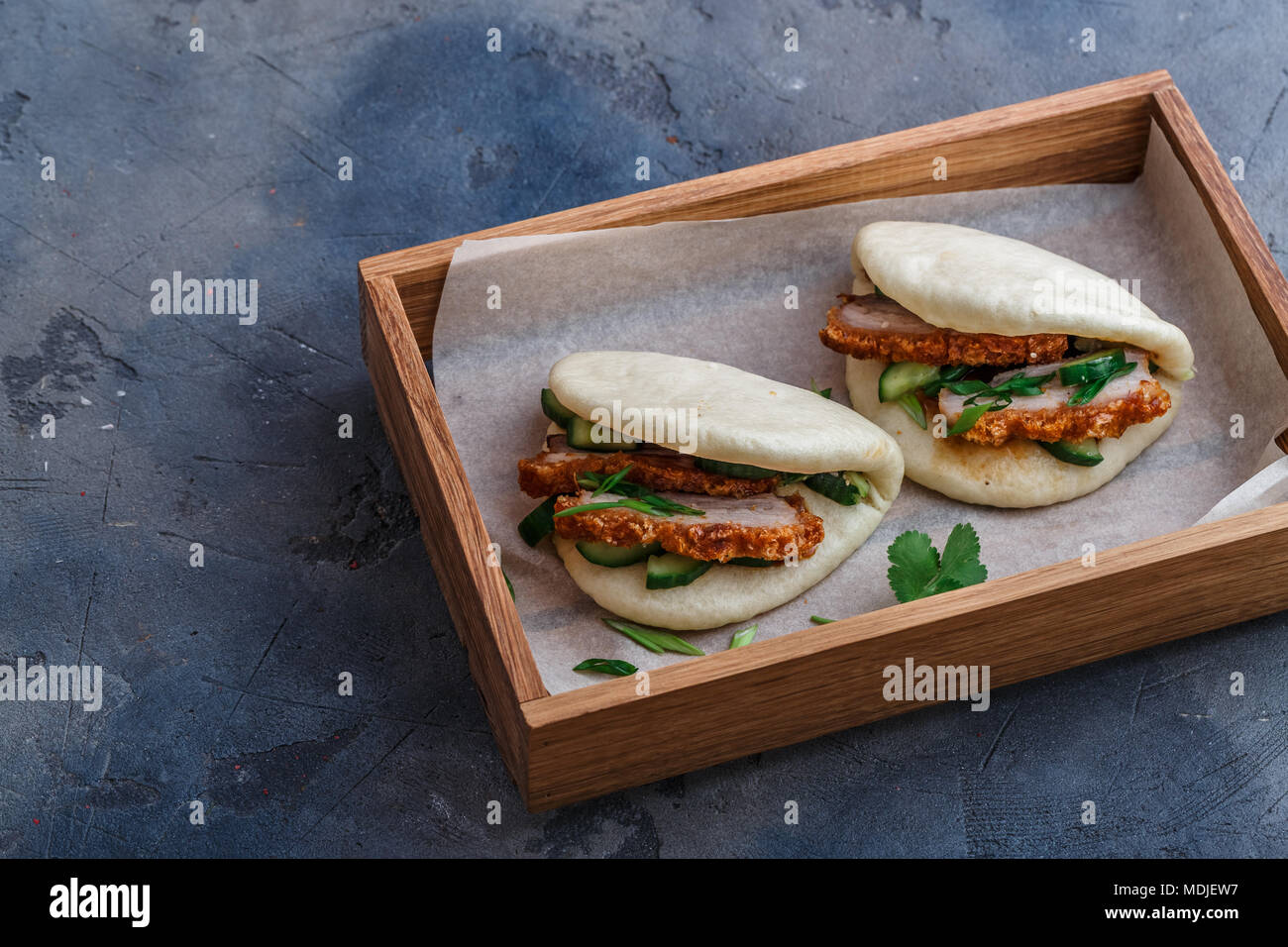 Two steamed buns with pork belly in a box, copy space Stock Photo - Alamy
