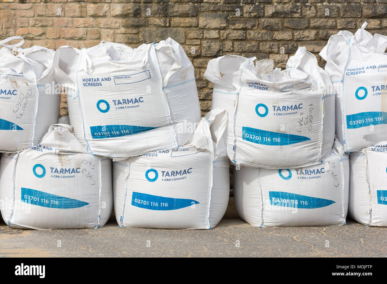 Bags of TARMAC mortar and screed stacked at a building site ready for ...