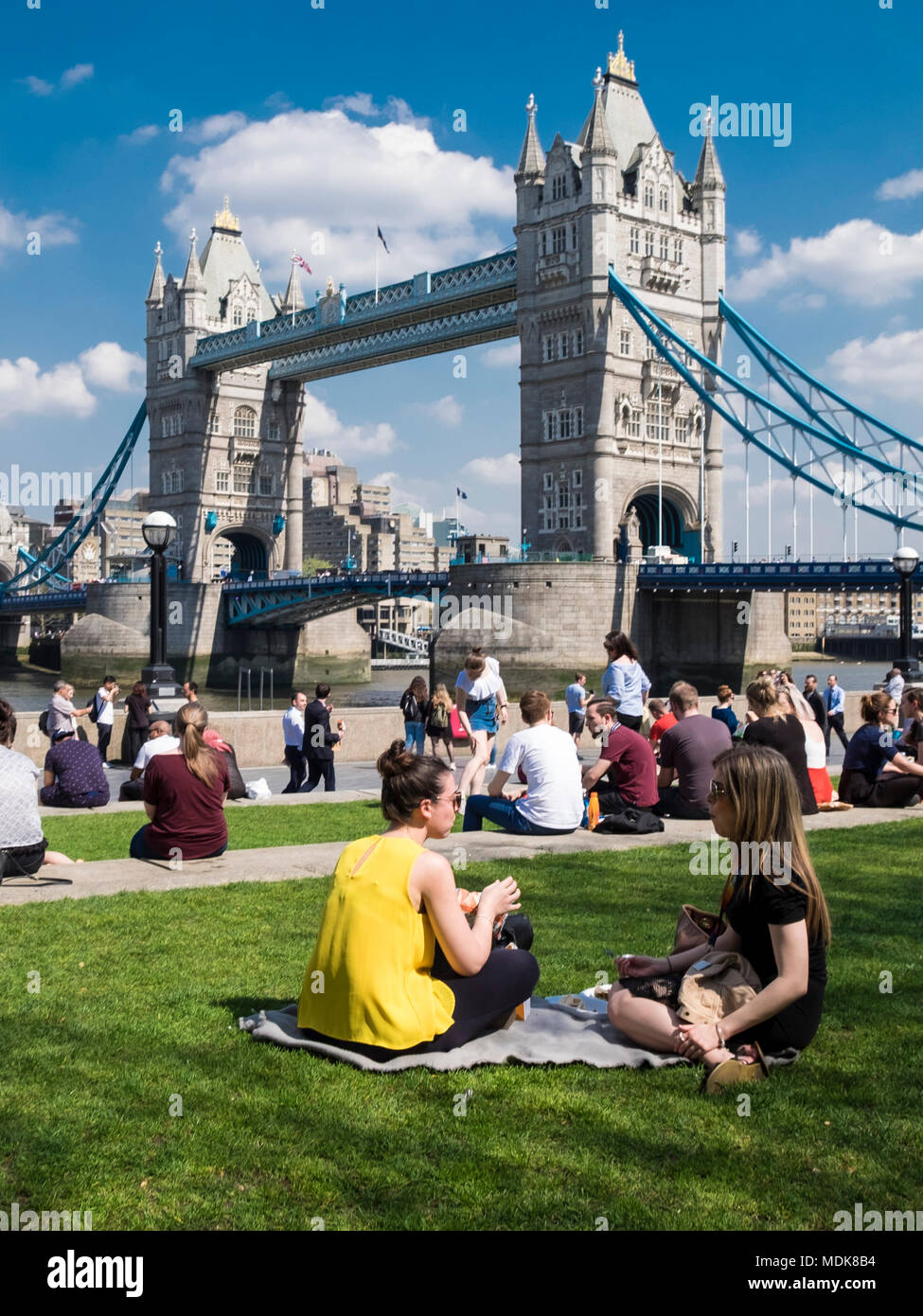 London, UK, 29th April 2018. Workers sun themselves by Tower Bridge ...
