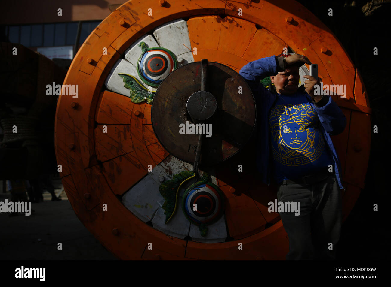 Lalitpur, Nepal. 20th Apr, 2018. A man rests using his phone on the ...