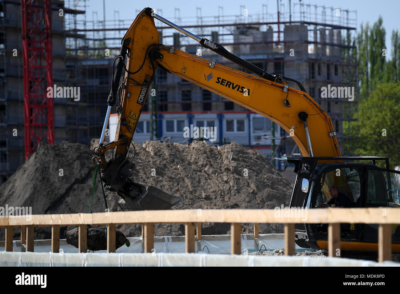 20 April 2018, Germany, Berlin: A crane lifts a defused WWII bomb from ...