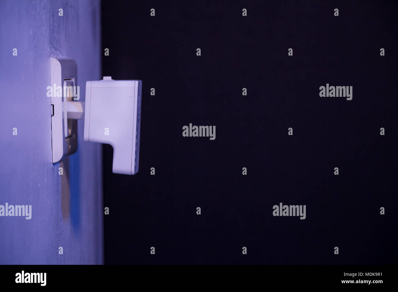 WiFi repeater in electrical socket on the wall. Device that help to ...