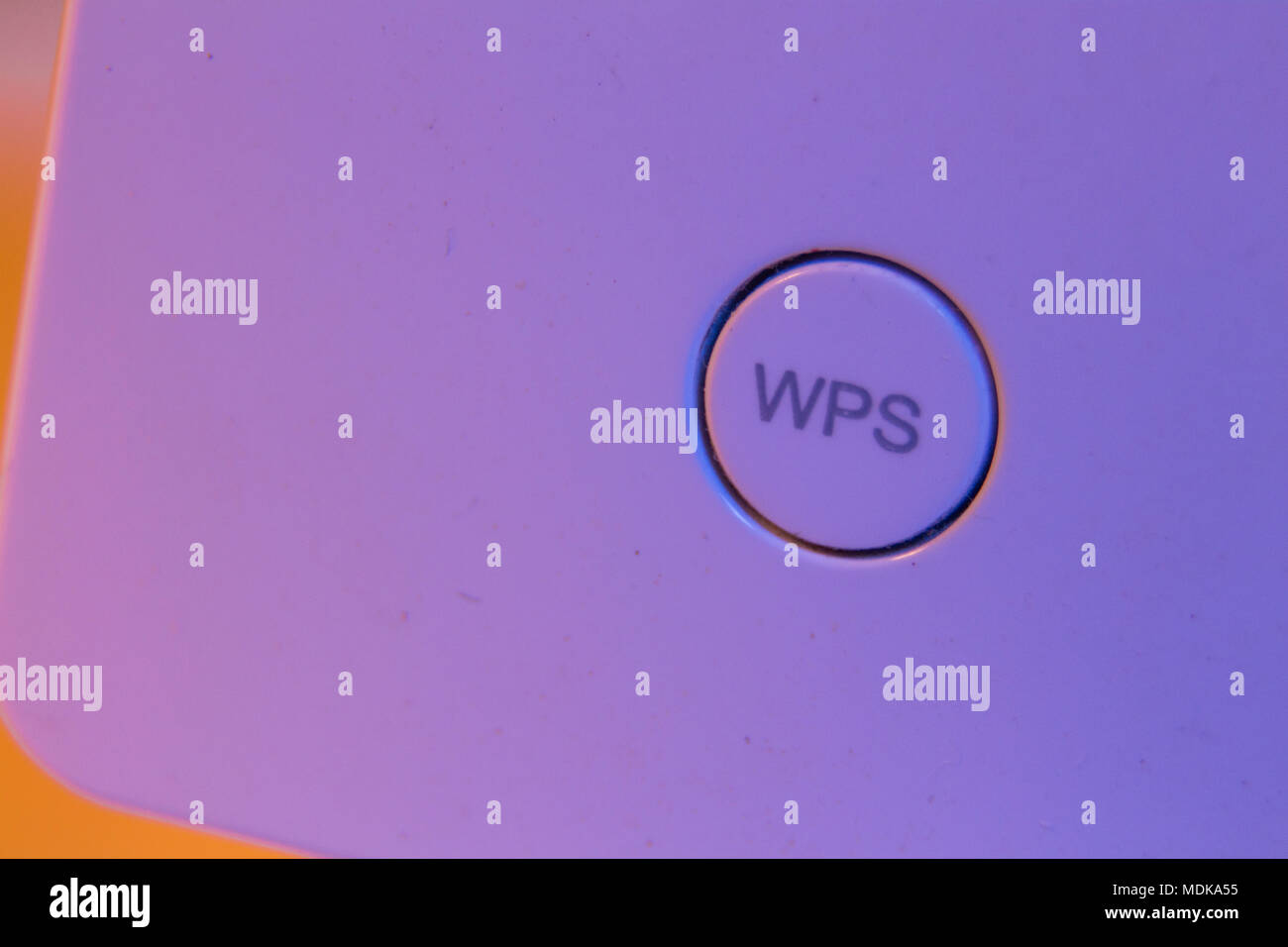 Macro closeup on WiFi repeater WPS button. The device is in electrical ...