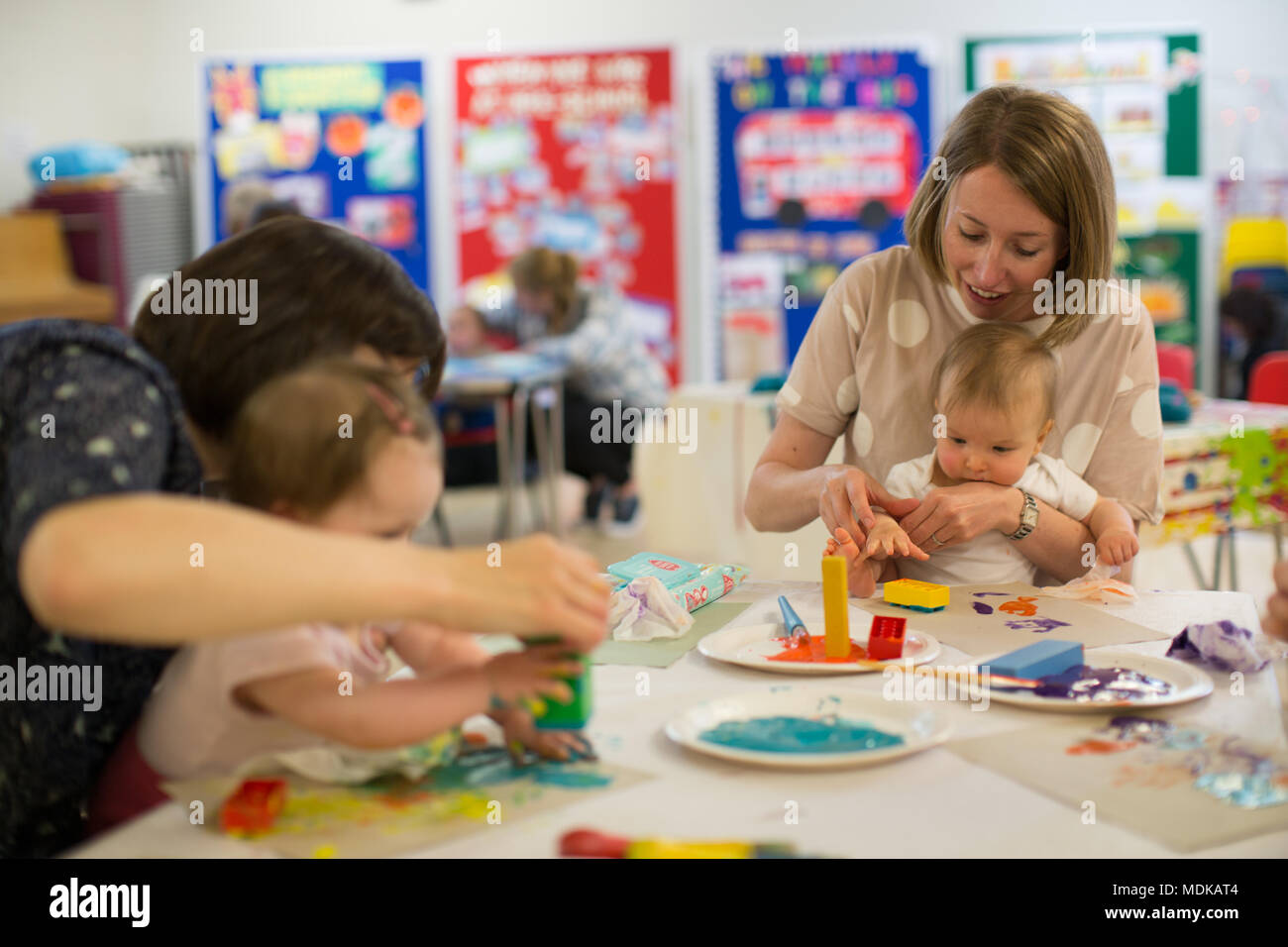 New mums at messy play with babies Stock Photo - Alamy