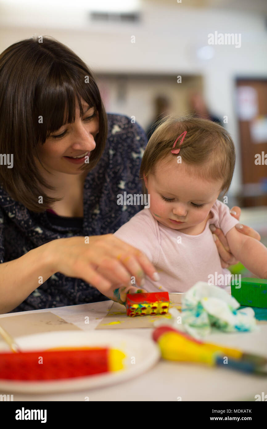 New mums at messy play with babies Stock Photo - Alamy