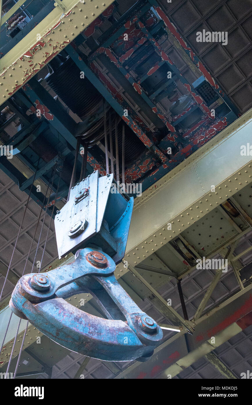 abandoned power station with huge steel beams and big steel crane hook ...