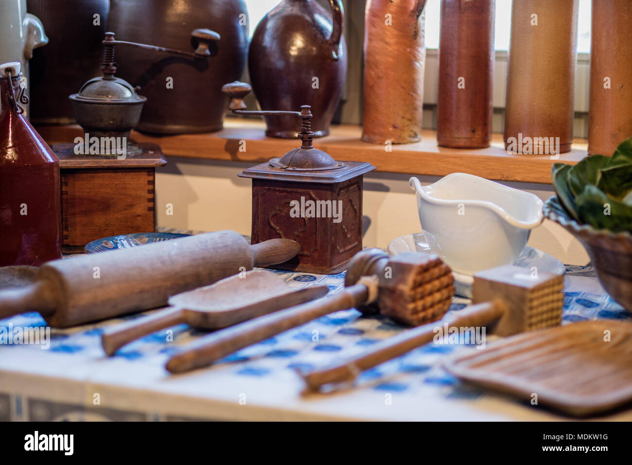 Old cooking tools on a wooden kitchen table. Accessories for cooking in ...