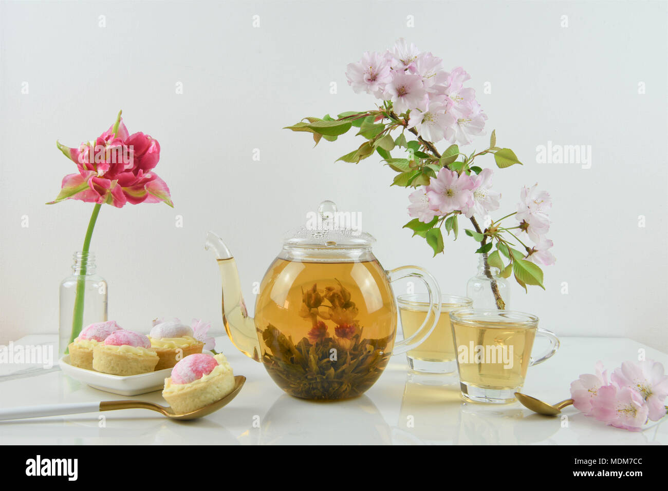 summer time flowering tea in glass teapot with cake Stock Photo - Alamy