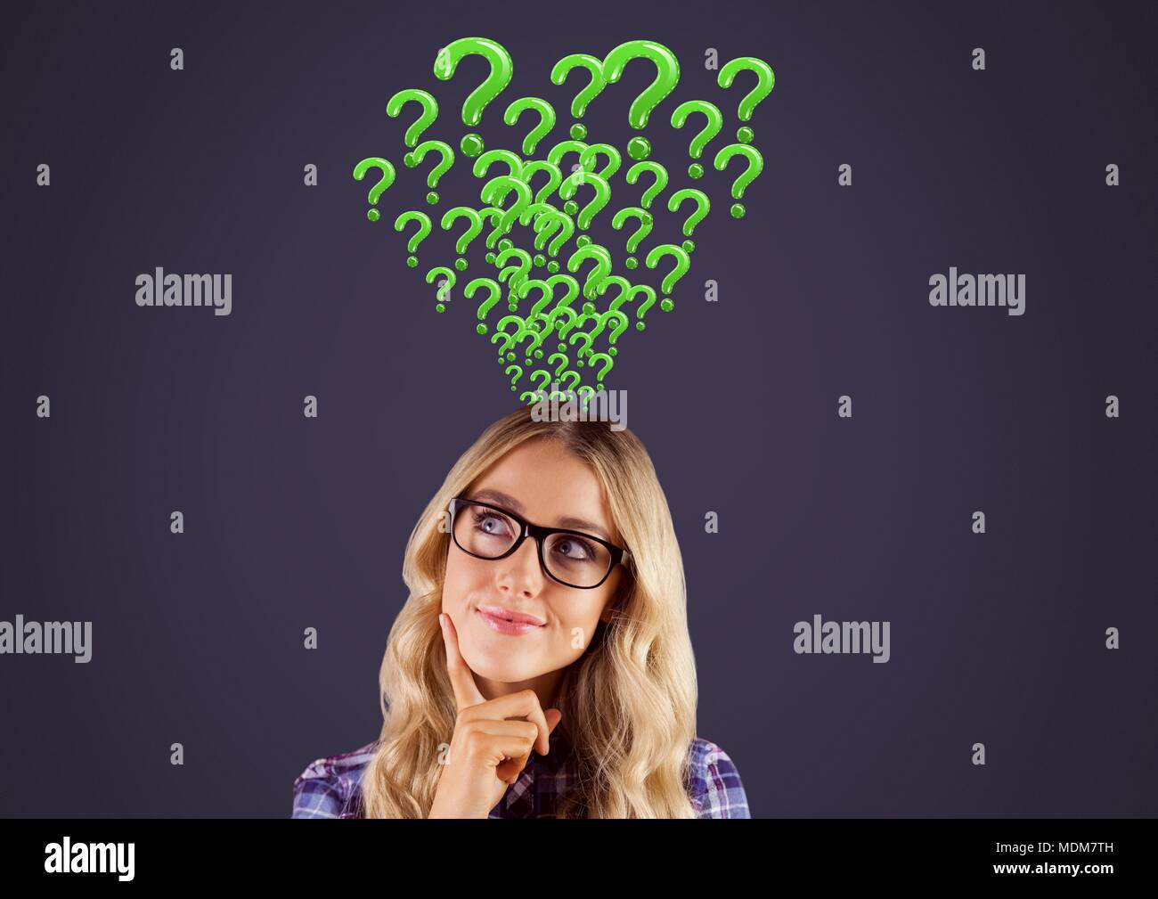 Woman thinking with green question marks Stock Photo - Alamy