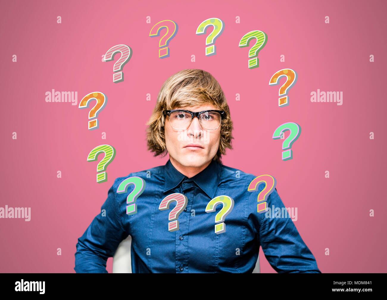 Man thinking with colorful funky question marks Stock Photo - Alamy