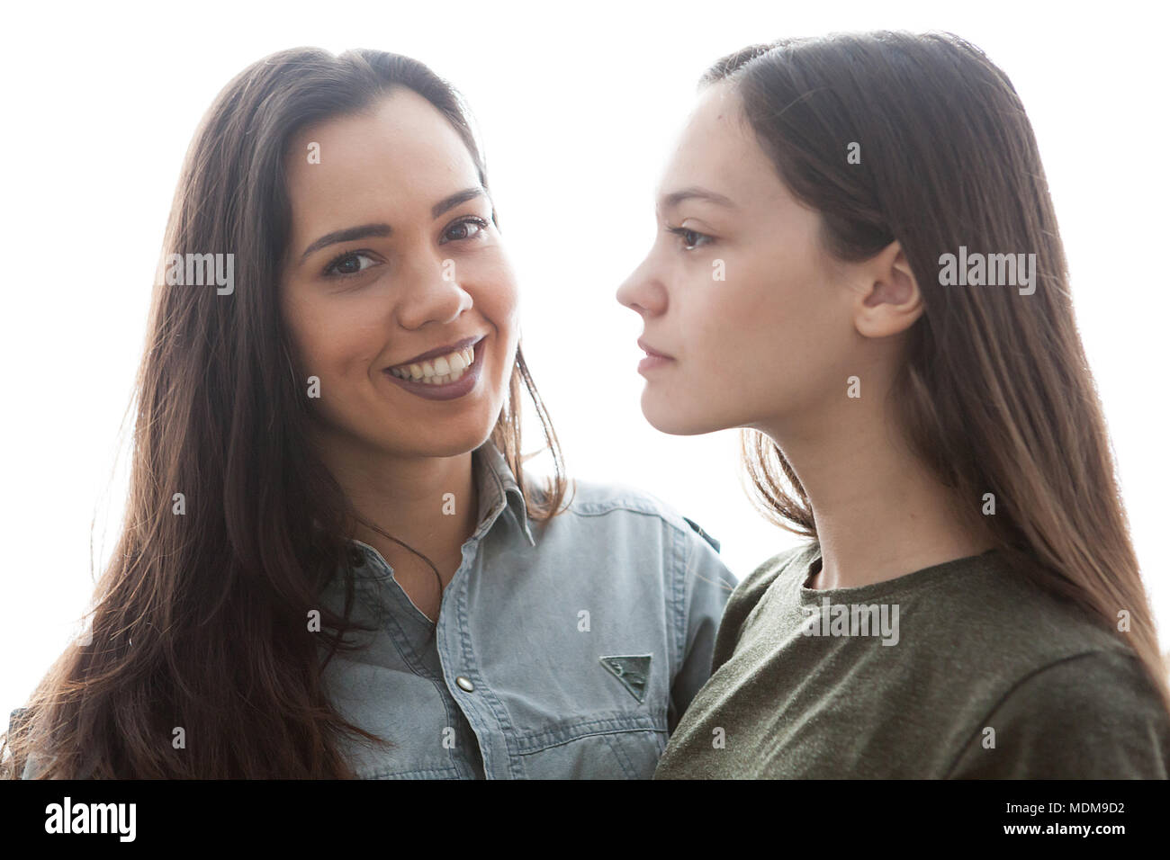 Two sisters standing together isolated hi-res stock photography and ...