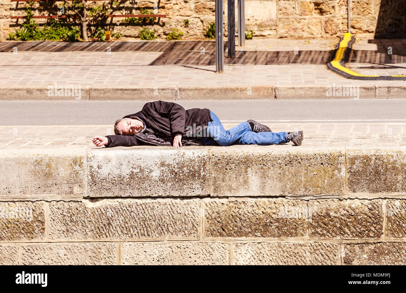 A man is sleeping on the embankment of the river Seine. France Paris ...