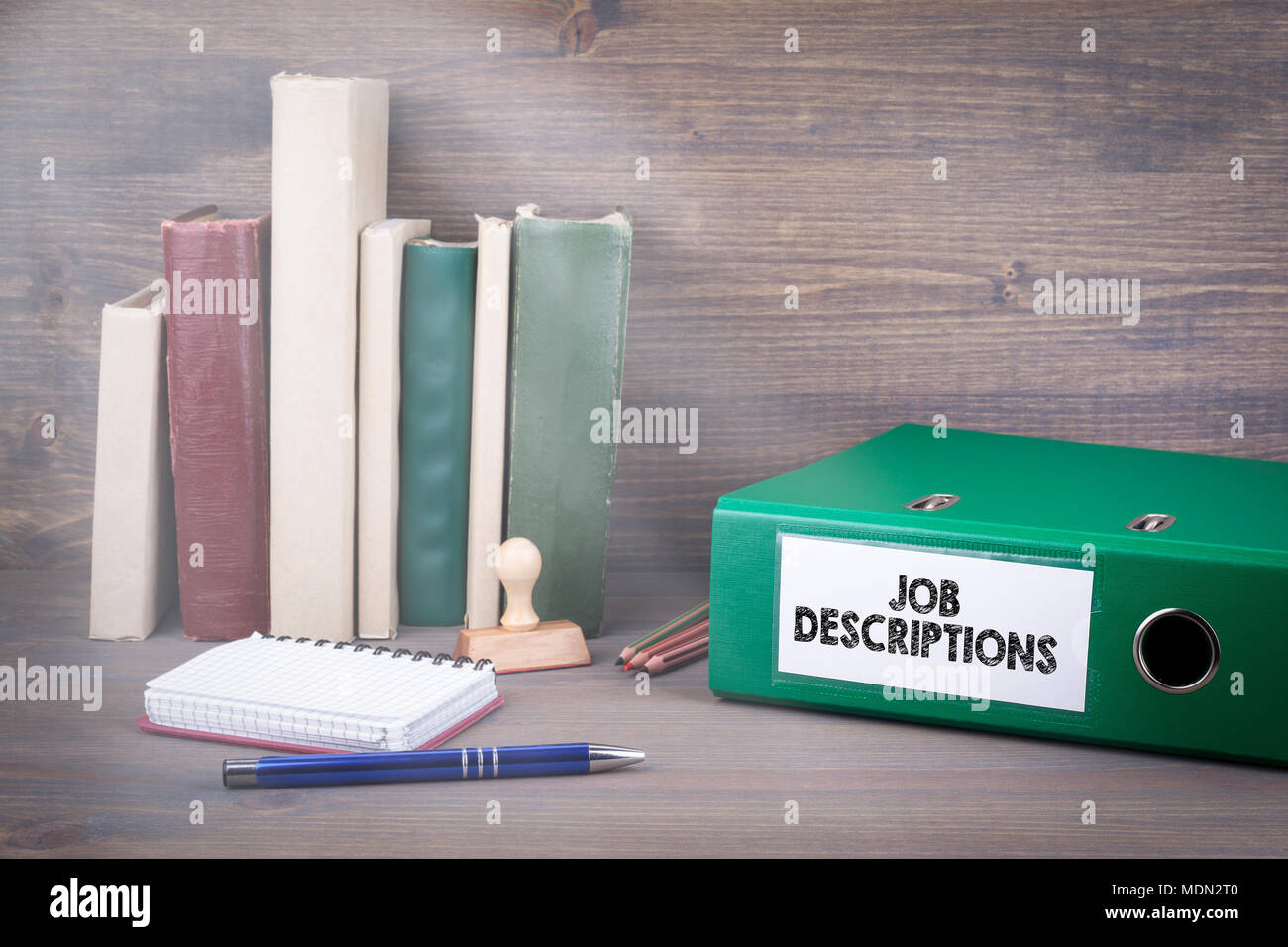 Job Descriptions. Binder on desk in the office. Business background ...