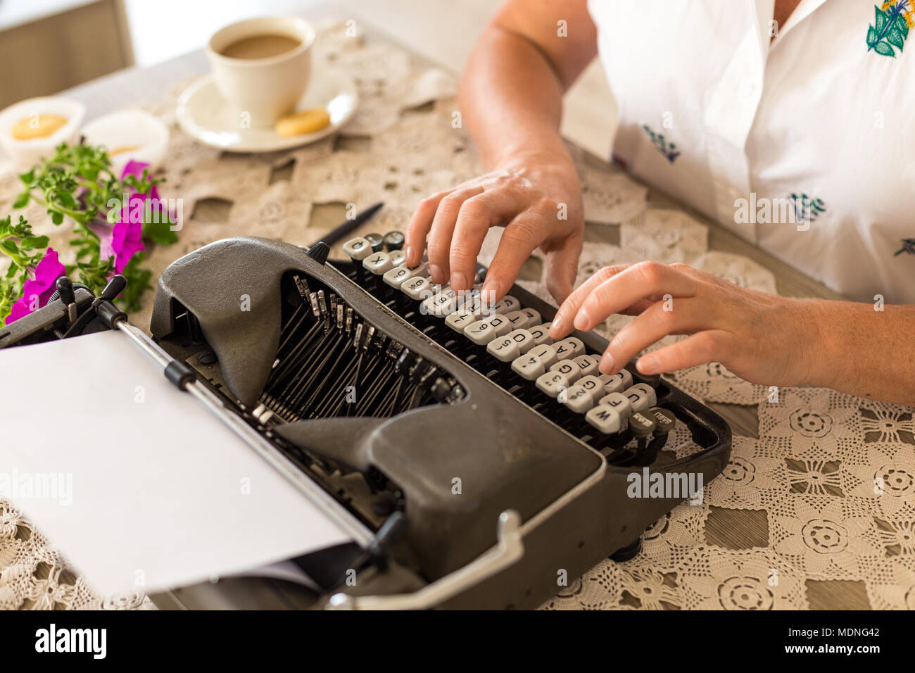 Writing concept. Author hands typing on retro typewriter placed on lace ...