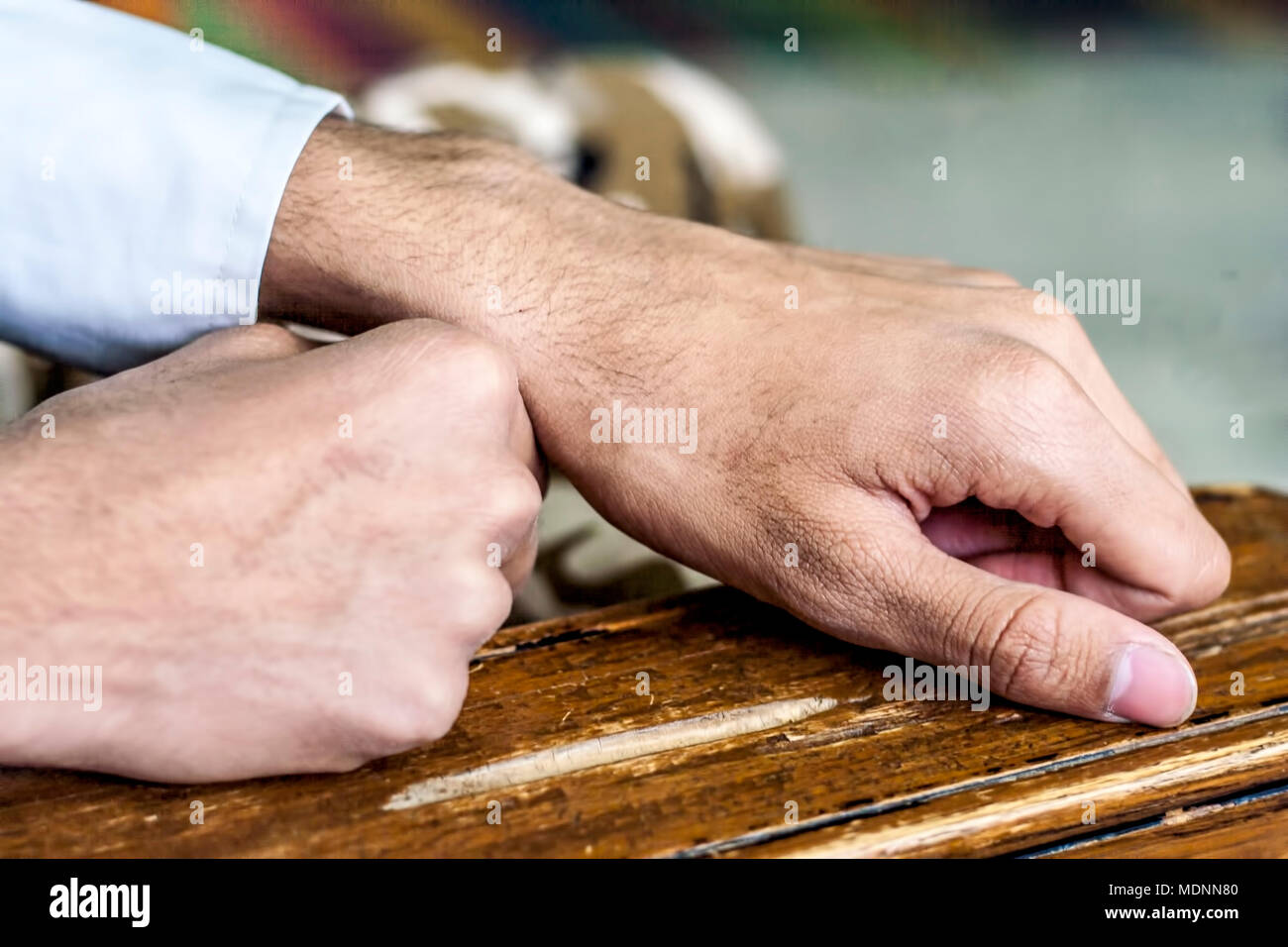 Close up of human hands writing on table without pen playing or ...