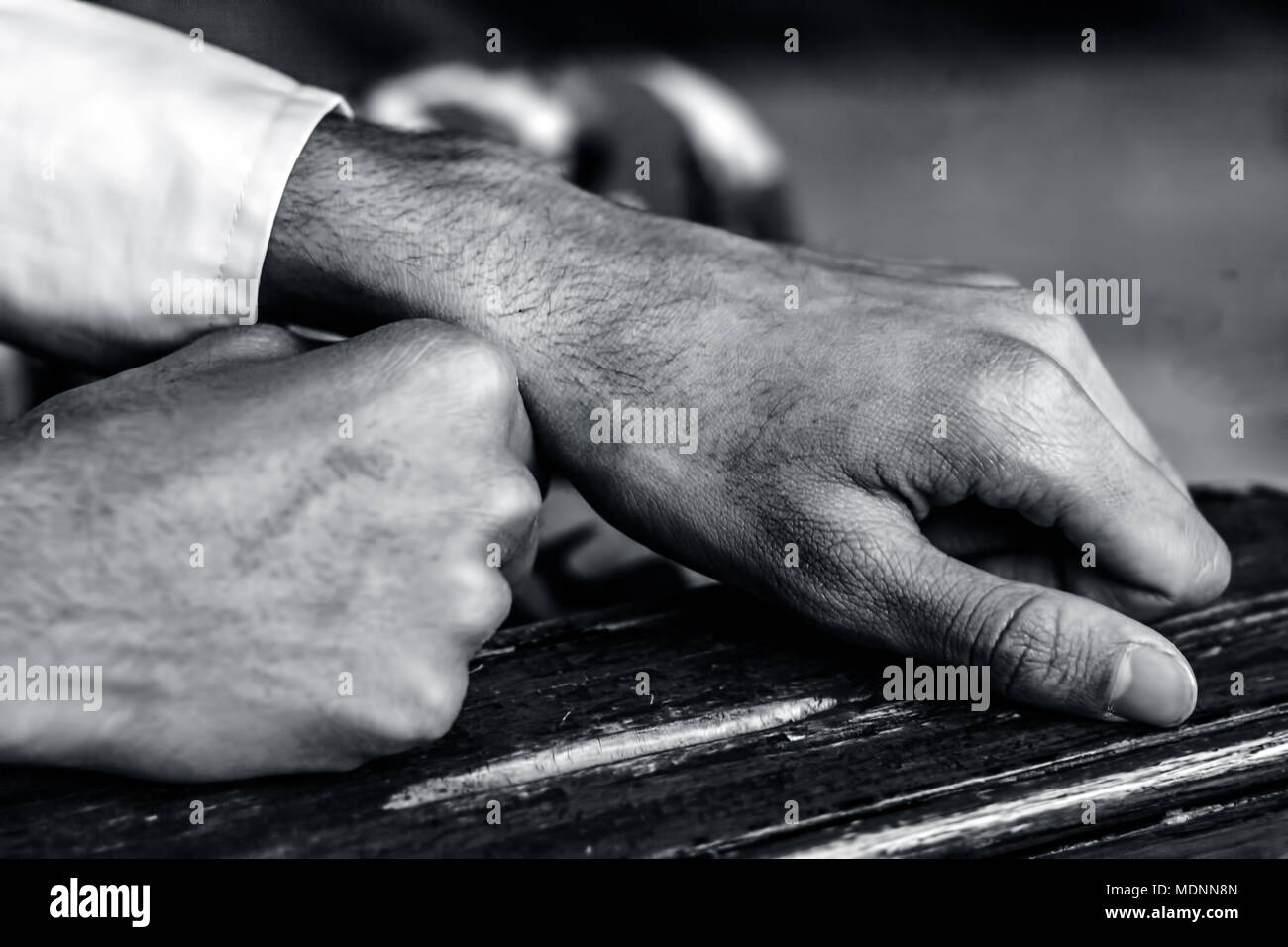 Close up of human hands writing on table without pen playing or ...