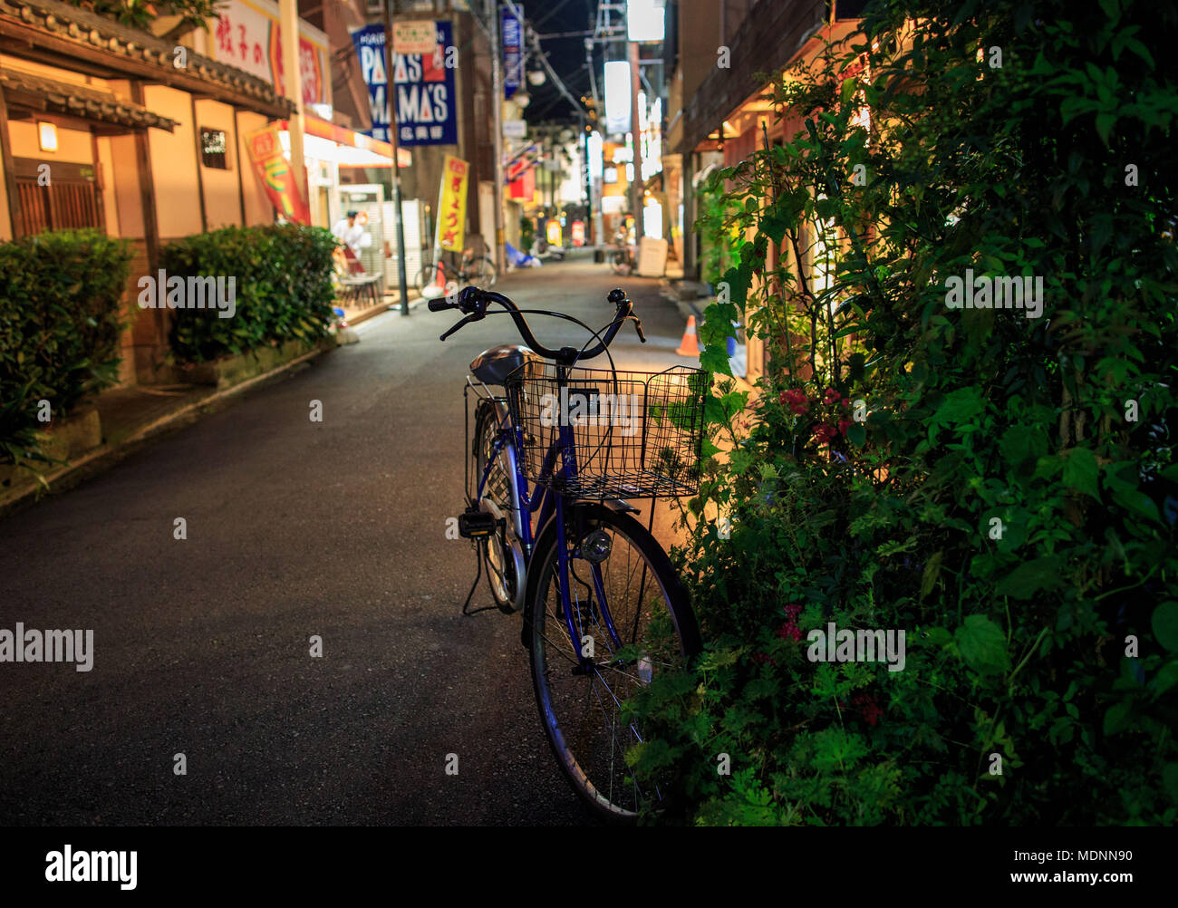 Osaka, Japan - September 2, 2013: A blue bicycle parked on the side of ...