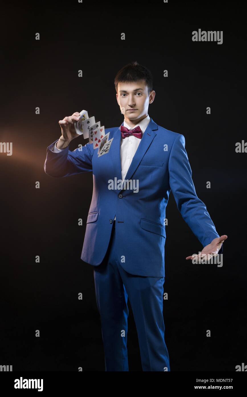 Magician showing tricks in the dark Stock Photo - Alamy