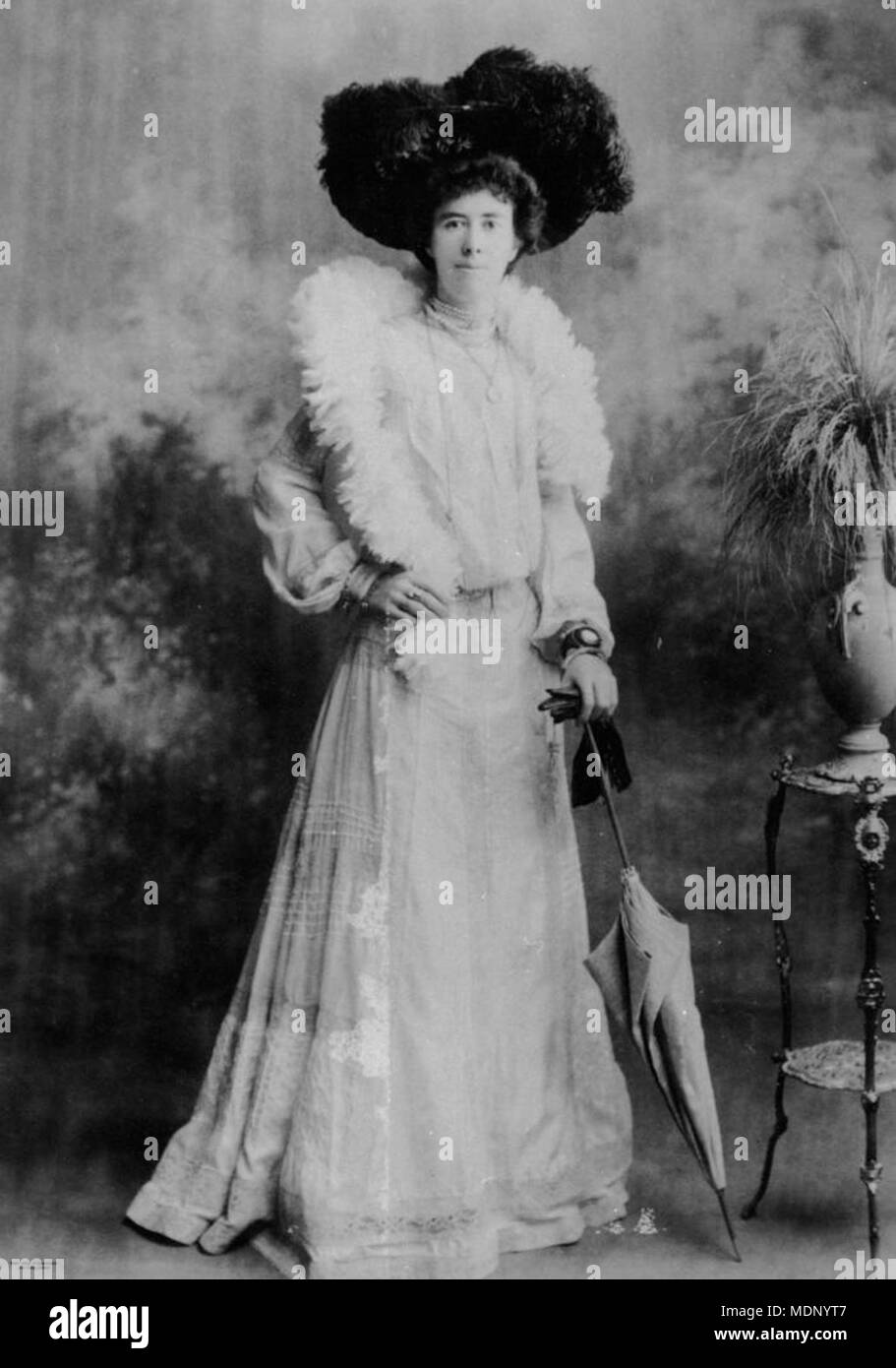 Woman wearing a large feathered hat and boa, posing for Stock Photo - Alamy