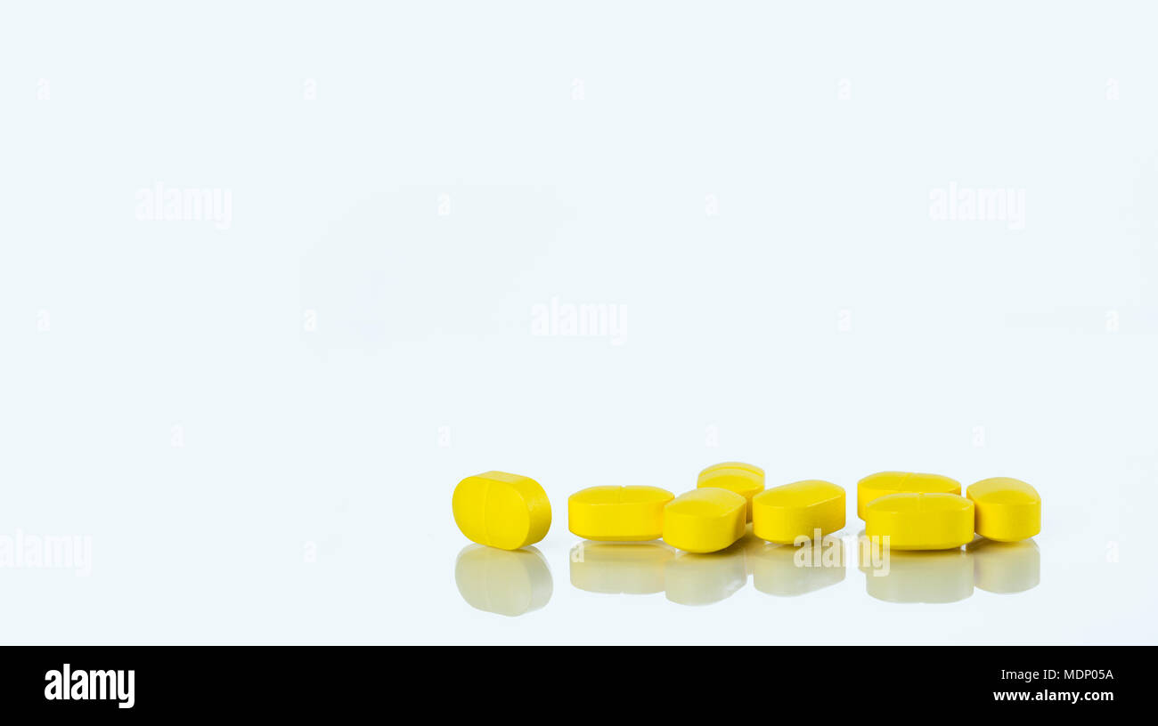 Yellow tablets pills isolated on white background with copy space for ...