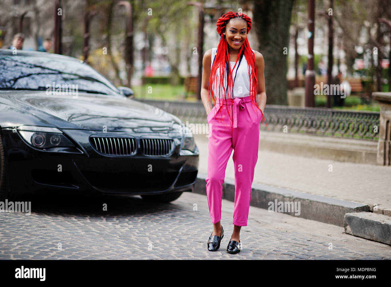 Fashionable african american girl at pink pants and red dreads posed ...