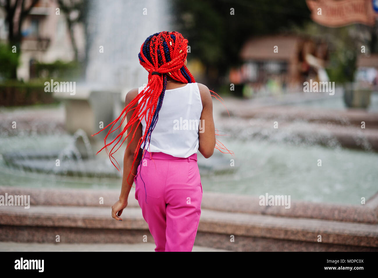 Fashionable african american girl at pink pants and red dreads posed ...
