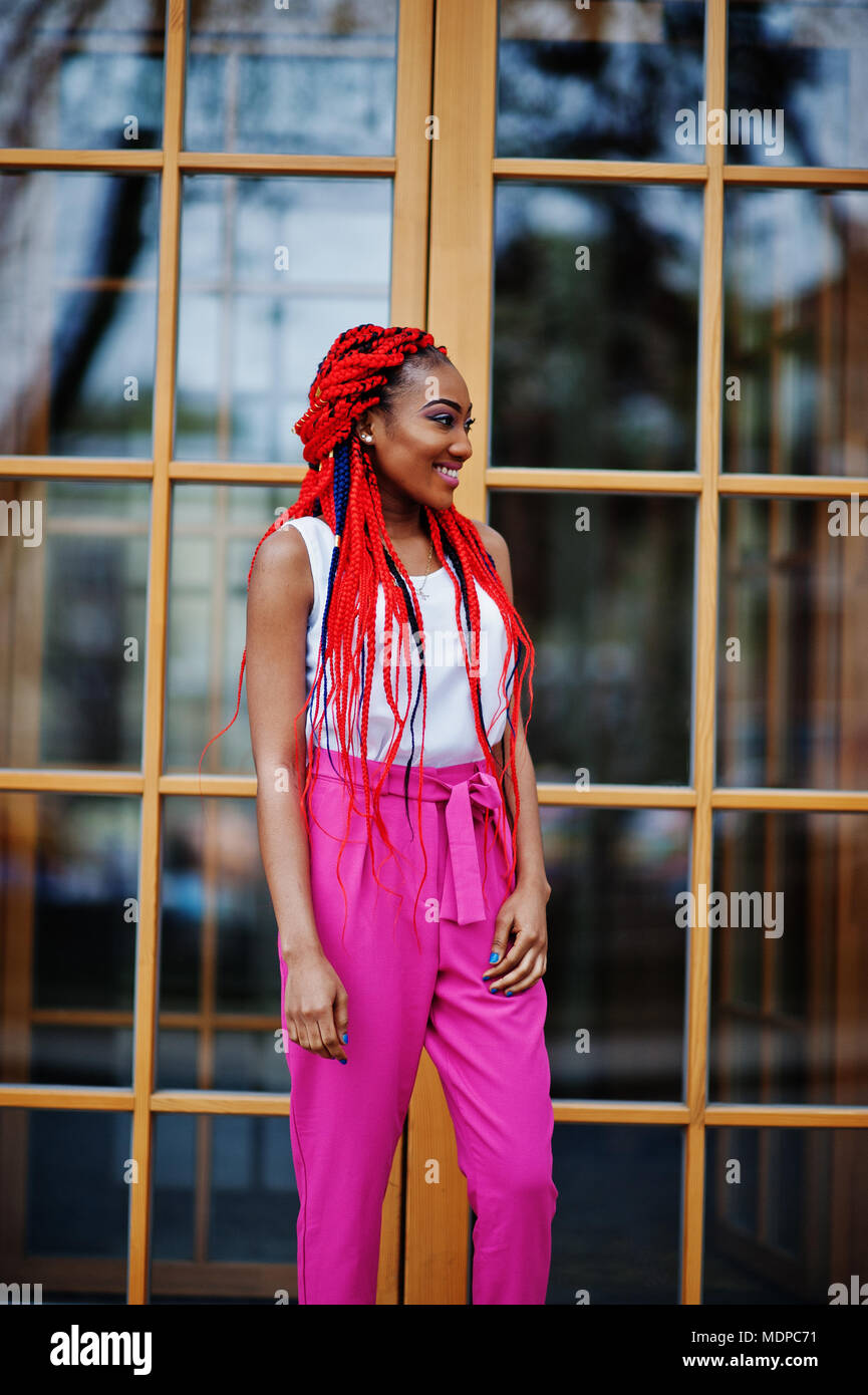 Fashionable african american girl at pink pants and red dreads posed ...