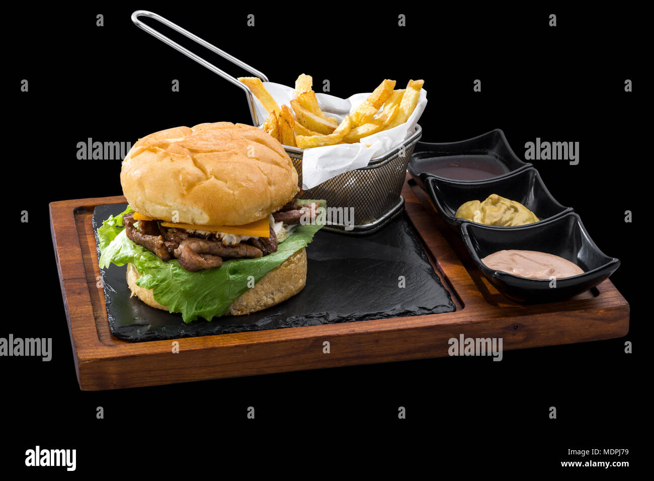 Delicious burger with roasted pieces of meat garnished with French ...