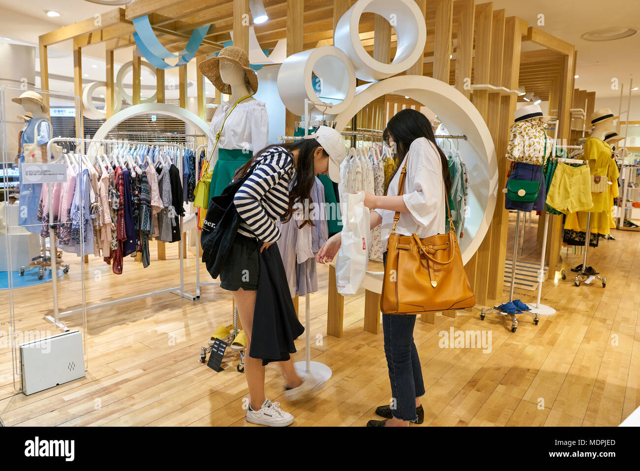 BUSAN, SOUTH KOREA - MAY 28, 2017: women browsing clothing TWEE store ...