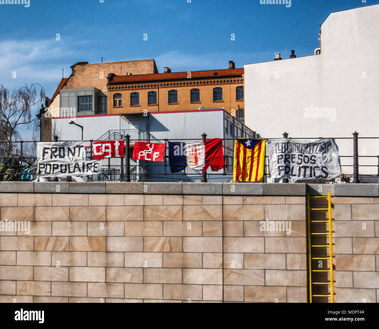 berlin Mitte. Political posters & banners on fence next to river Spree ...
