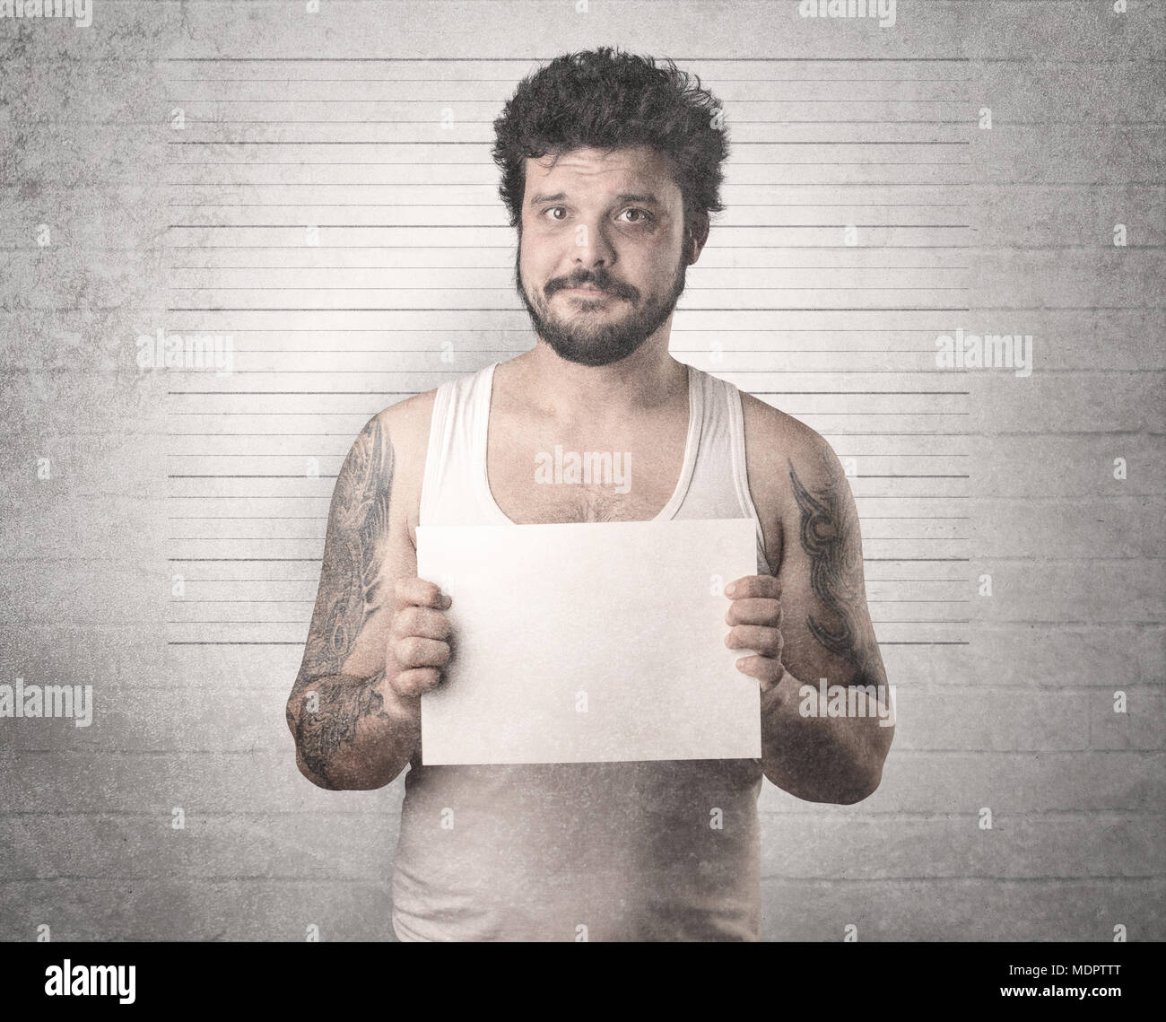 Gangster in front of a wall with table on his hand Stock Photo - Alamy