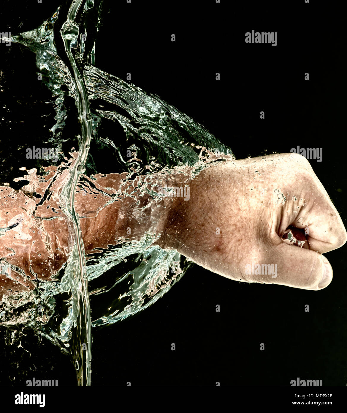 "Punching Through Water" - Close-up of a man's fist punching through ...