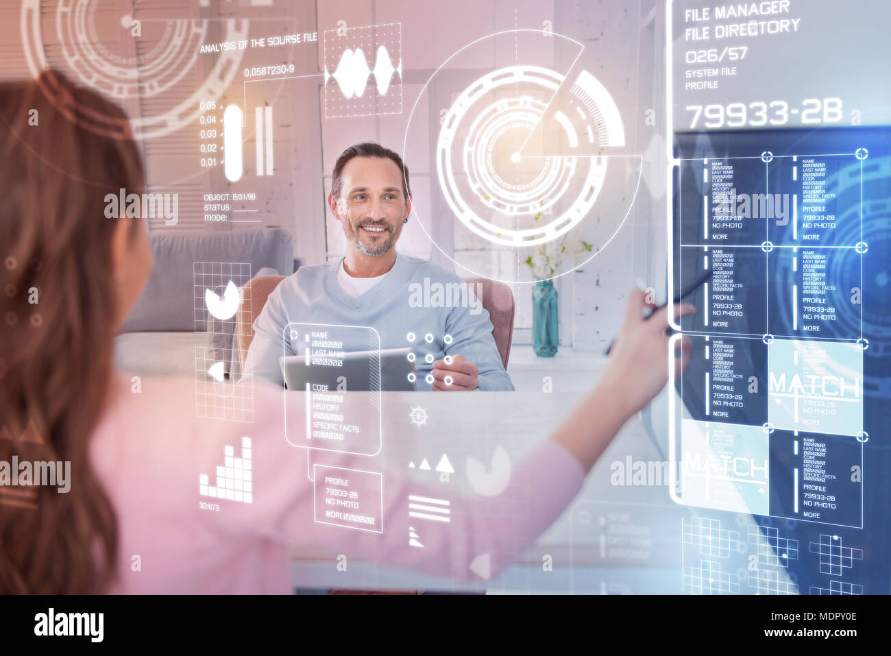 Clever girl pointing to the screen while talking to her teacher Stock ...