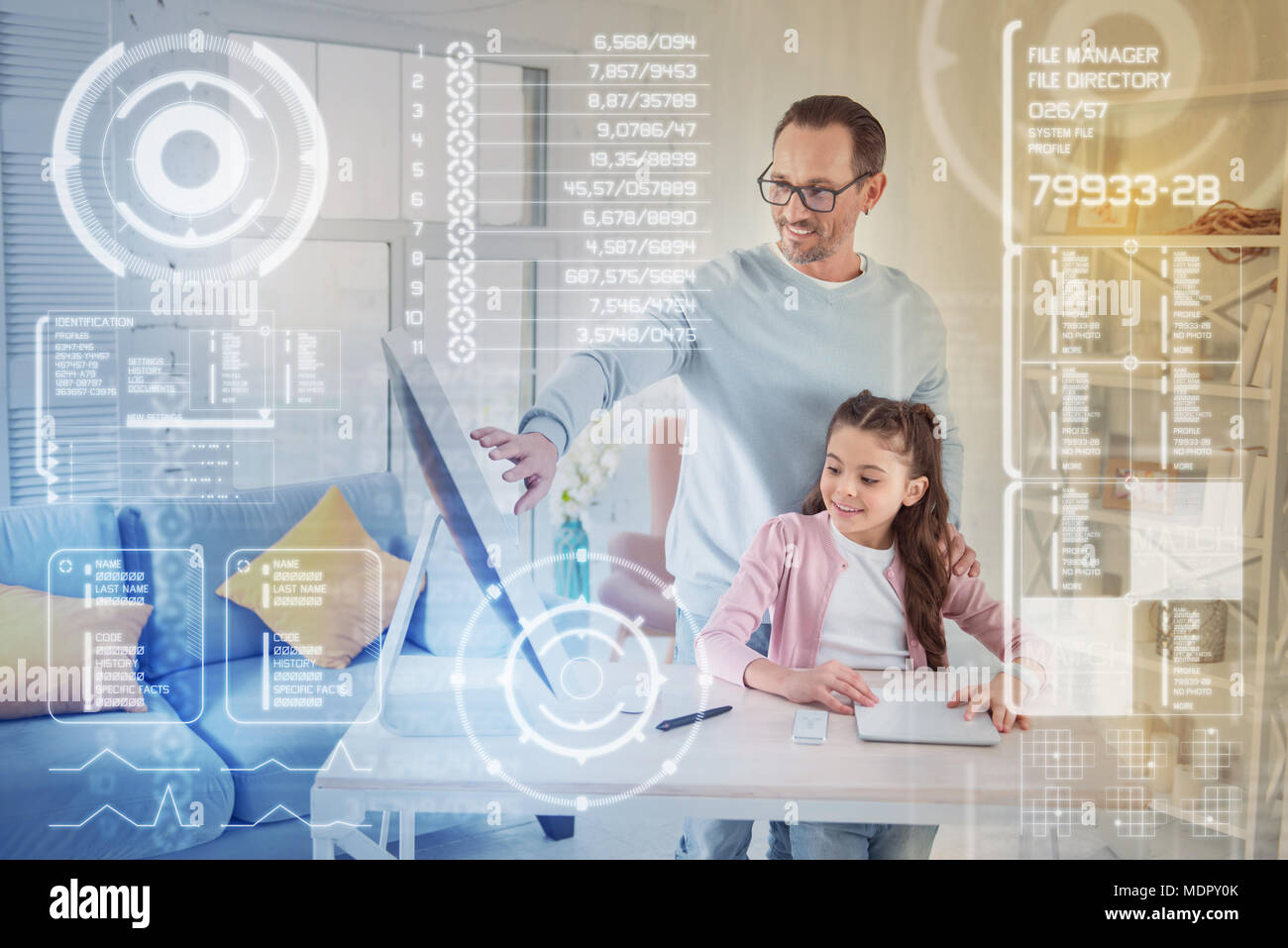 Positive father smiling while helping his hardworking daughter with ...